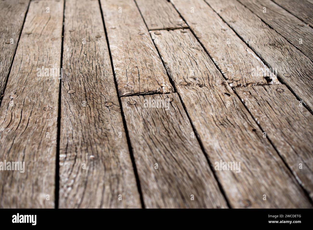 This vintage wooden surface showcases a weathered and distressed ...