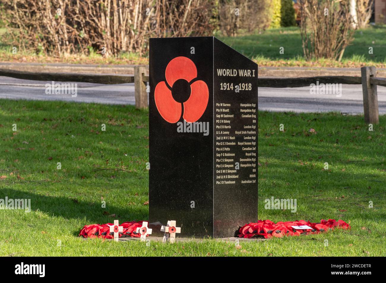 War memorial and poppies poppy wreaths in small park in Four Marks ...