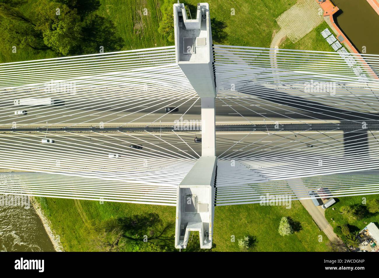 Cars drive on massive Redzinski Bridge over river with dark green water ...