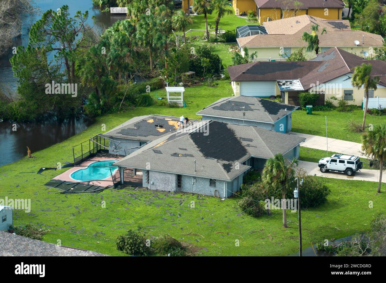 Hurricane Ian destroyed house with damaged roof and lanai enclosure ...