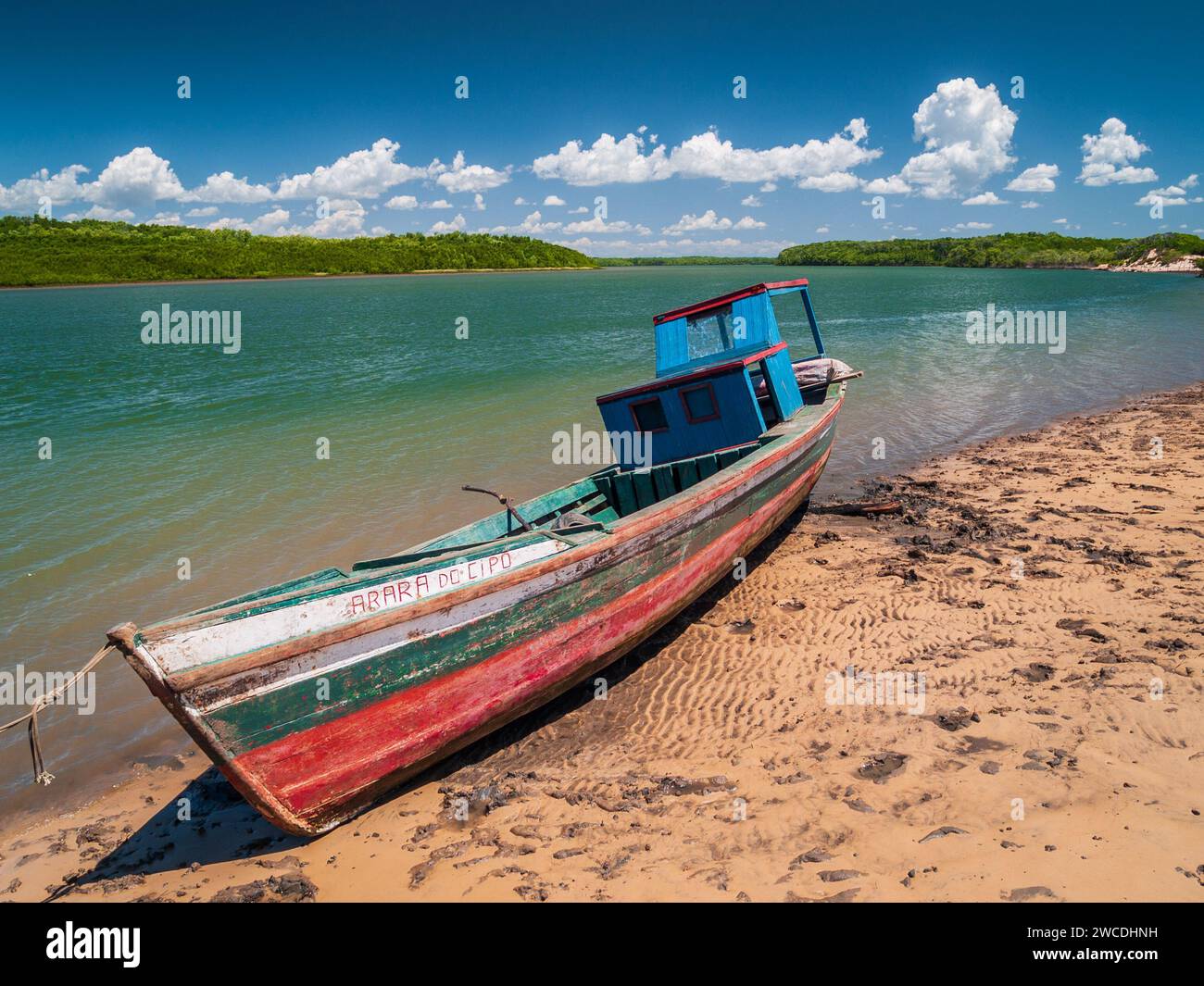 Landscape with colourful wooden fishermen's boat stranded on the river ...