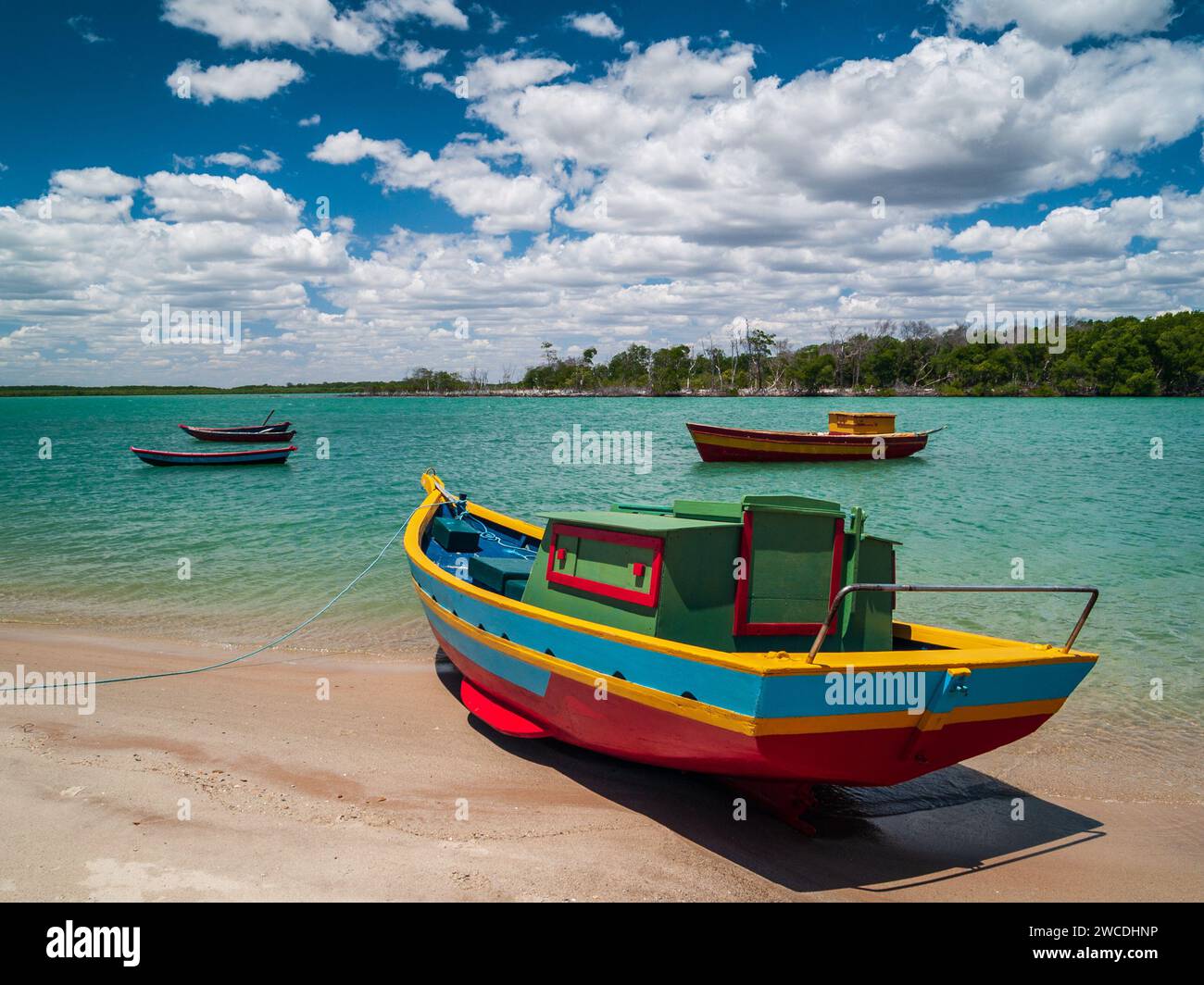 Landscape with colourful wooden fishing boats stranded on the river in ...