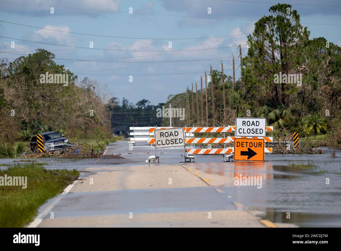 Road closed for roadworks and danger of flooding with warning signs ...