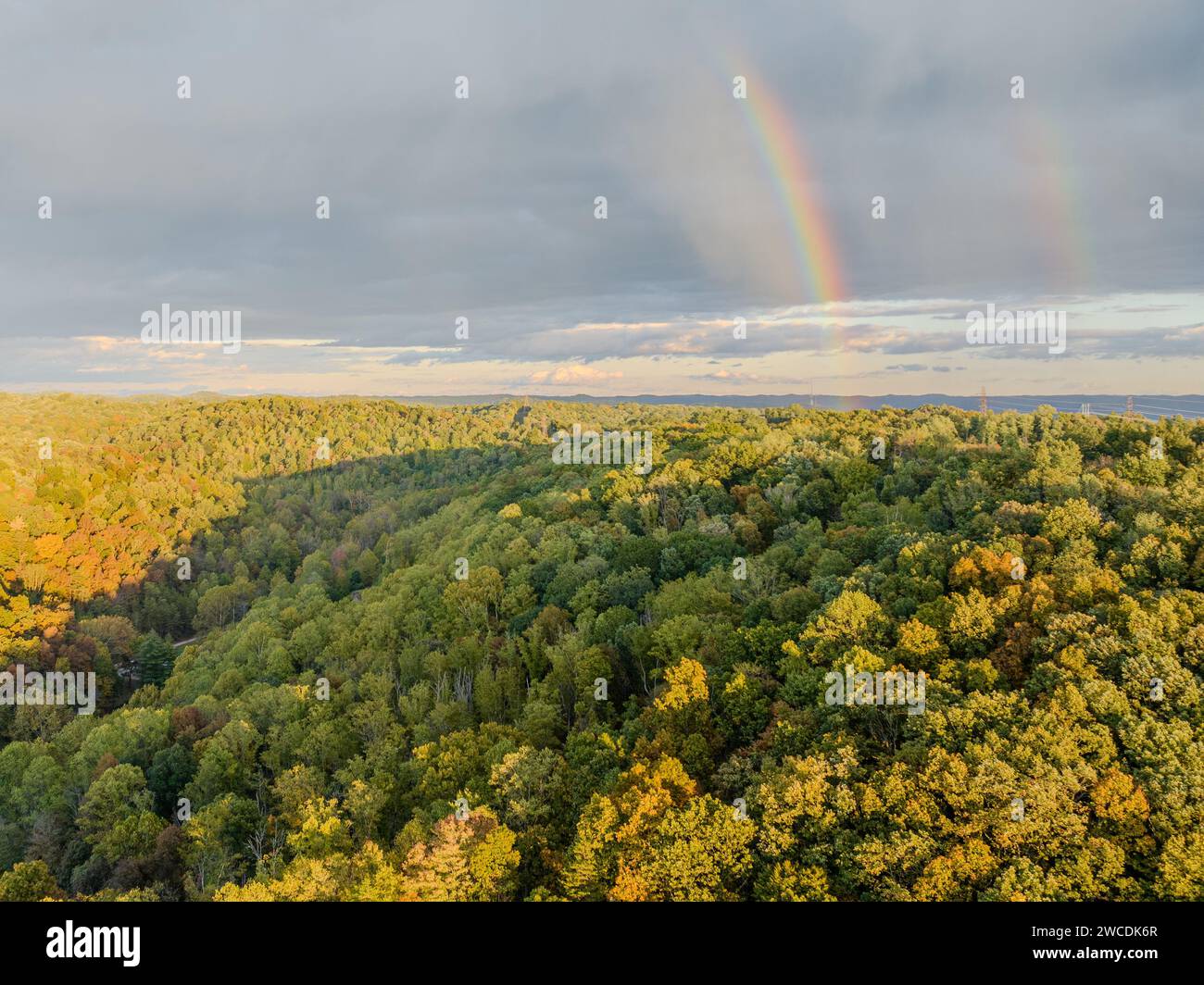 A faint sunset rainbow over Coopers Rock State Forest with fall foliage ...
