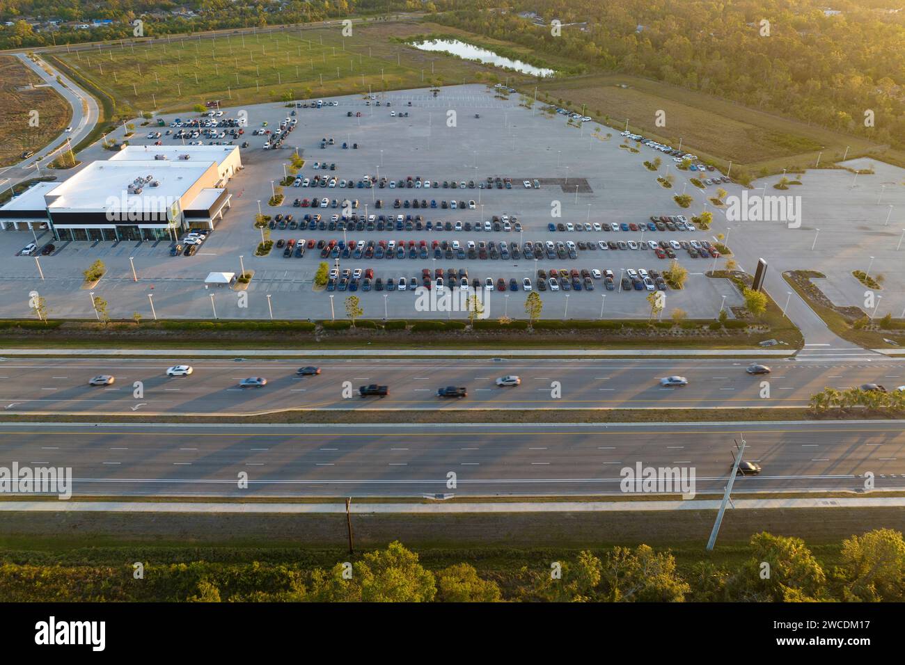 View from above of dealers outdoor parking lot with many brand new cars ...