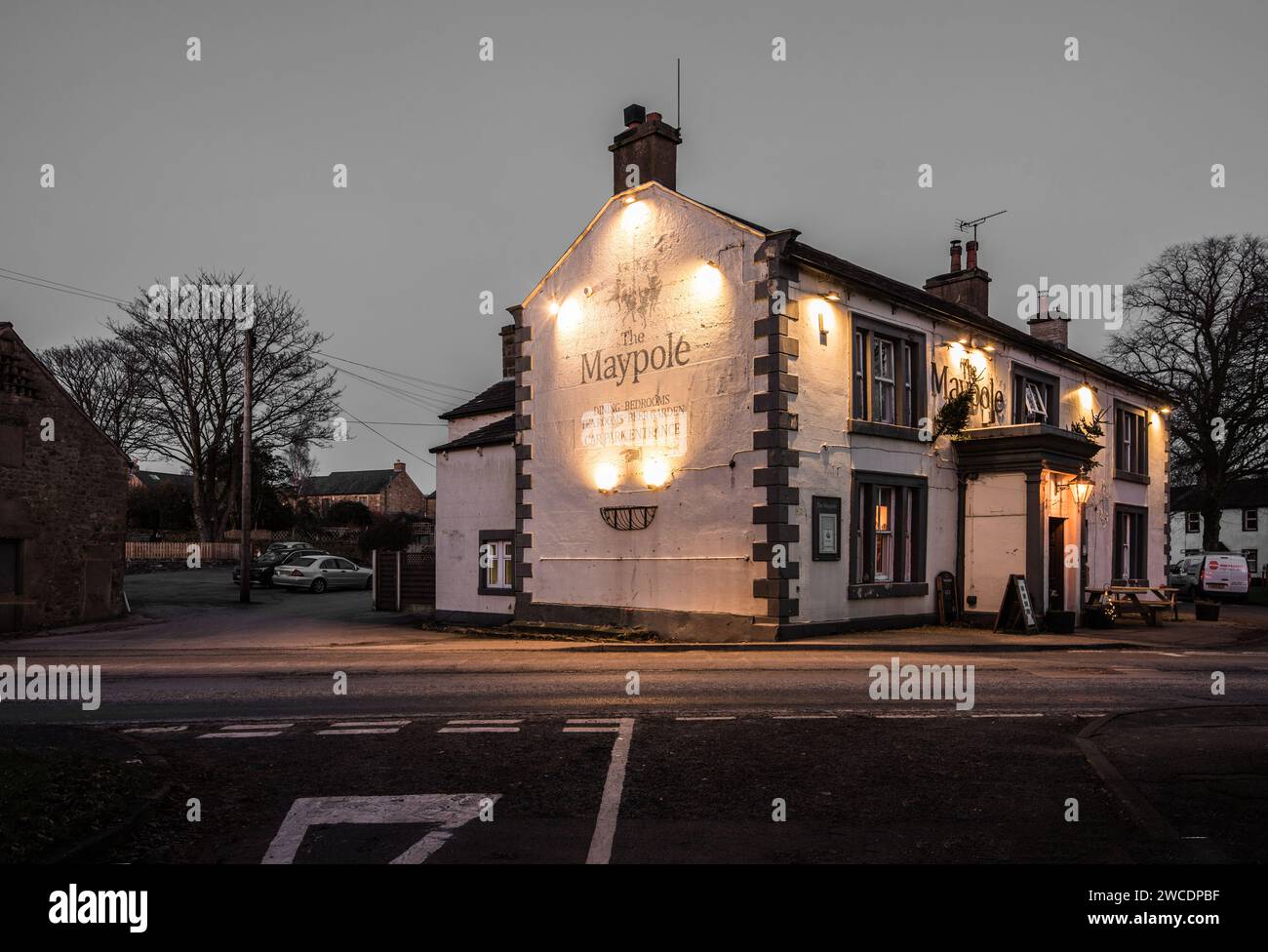 Lights come on as the sun has just gone down. This is The Maypole Inn ...