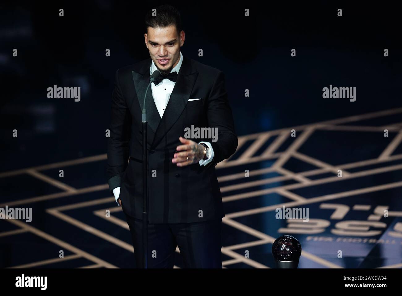 Ederson on stage after receiving the award for The Best Men's ...