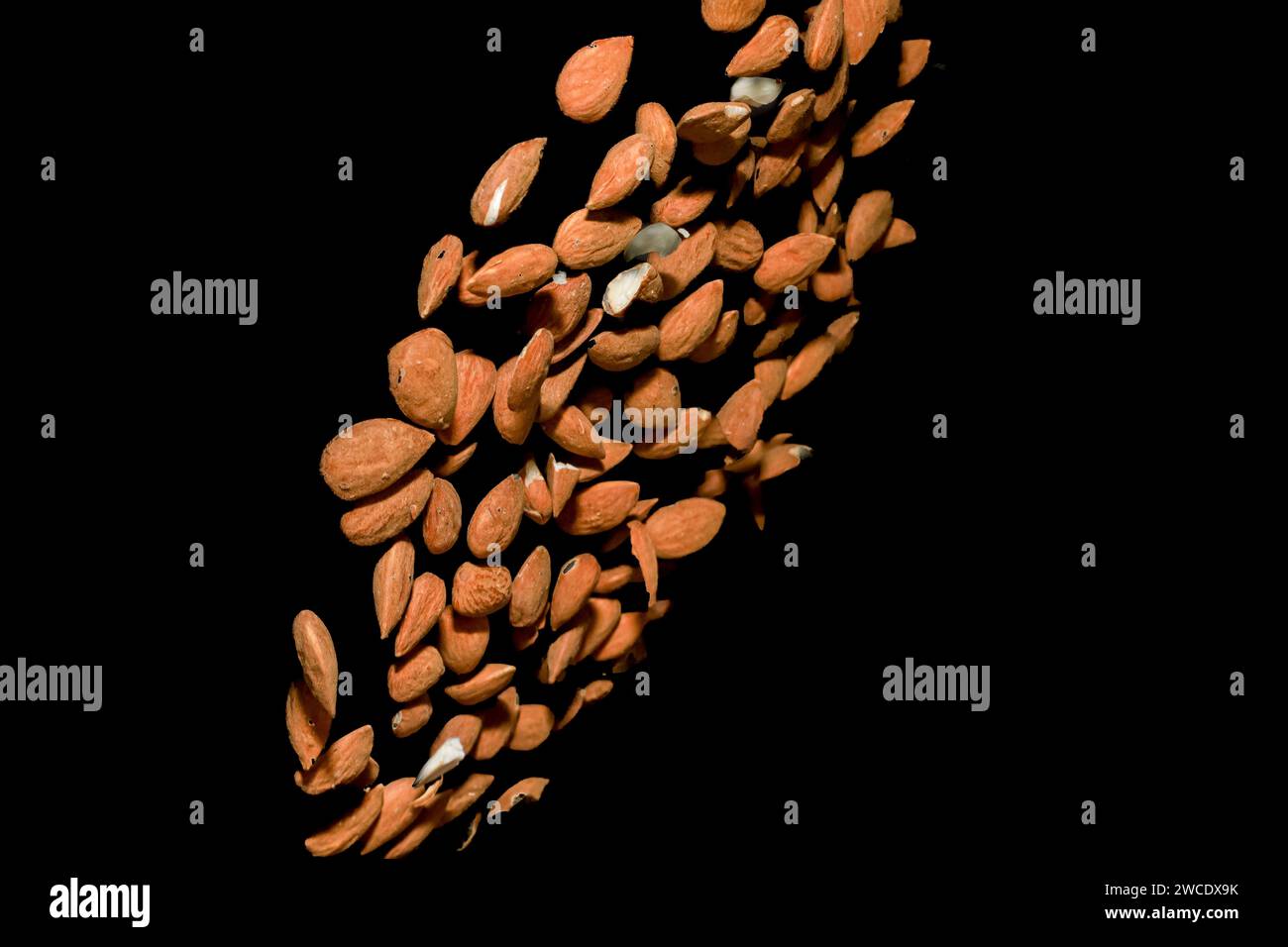 Many almond falling isolated on black background. Narrow focus. Thrown ...