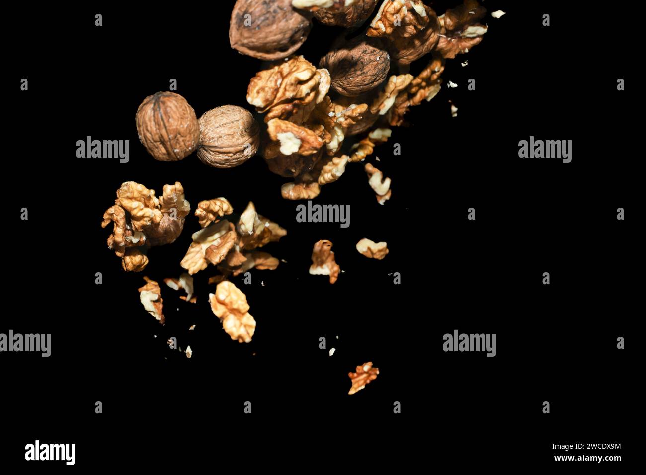 Many falling wallnuts isolated on black background. Narrow focus ...