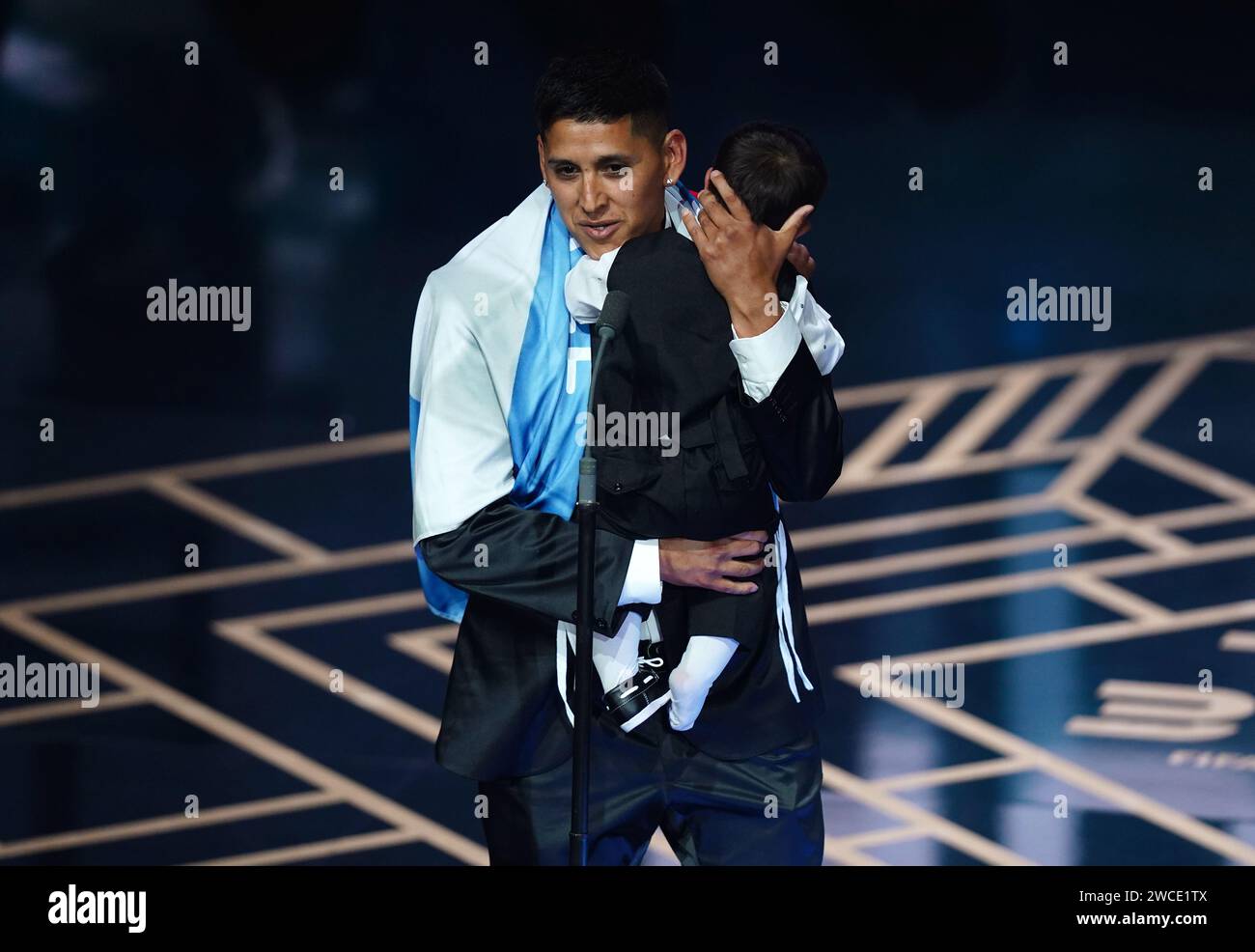 Hugo Daniel Iniguez on stage with his son after receiving the FIFA Fan ...