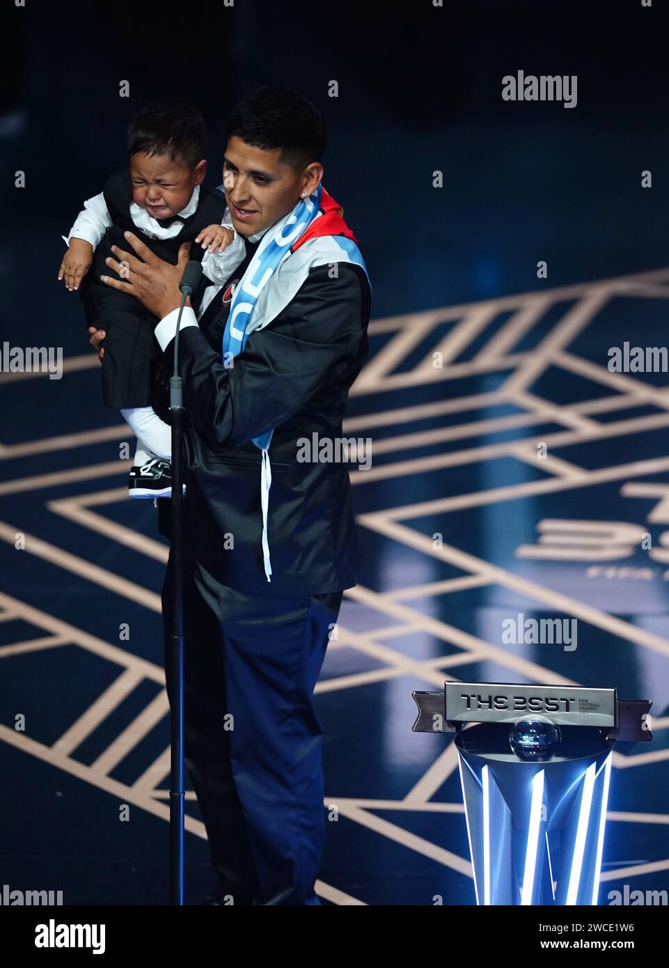 Hugo Daniel Iniguez on stage with his son after receiving the FIFA Fan ...