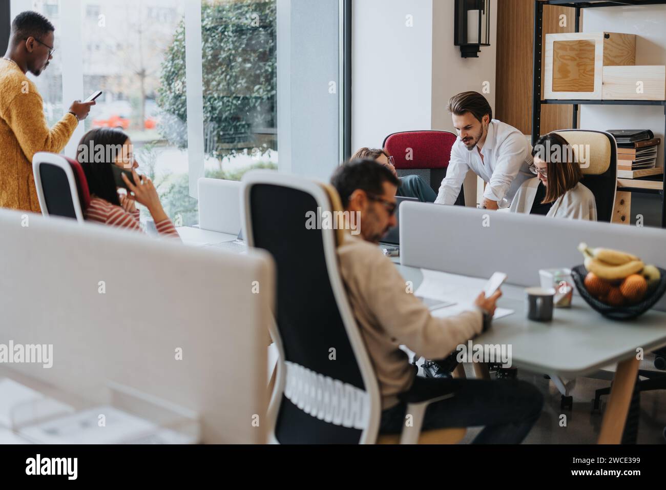 Multi generational professionals collaborate in a modern office ...