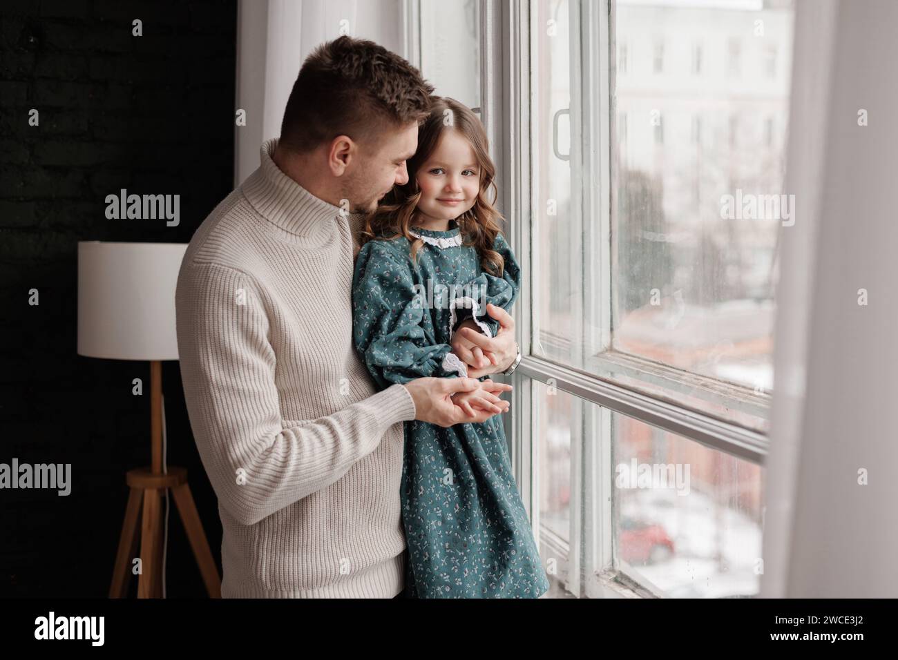 Fathers day. Happy loving young dad embracing adorable little daughter ...