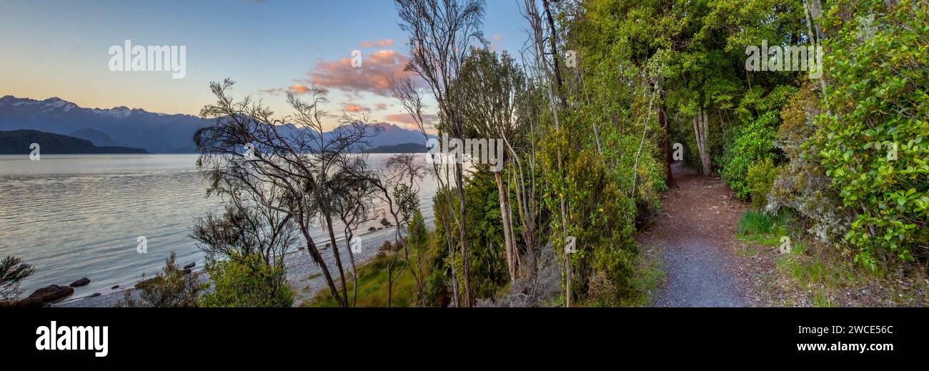 Sunset, Frasers Beach and a hiking trail next to Lake Manapouri ...