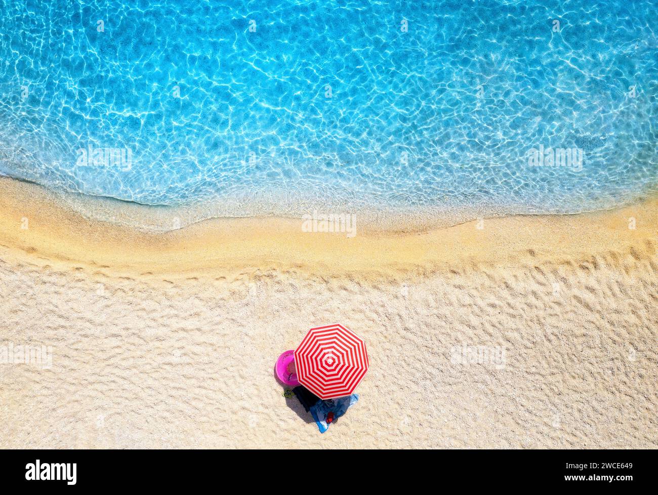 Aerial view of blue sea, empty sandy beach and umbrella in summe Stock ...