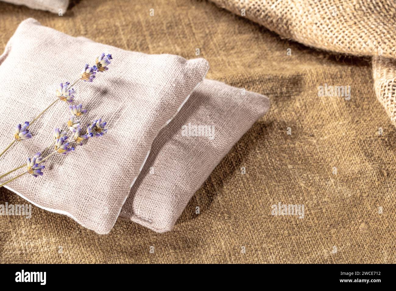 Rustic peasant-style pillows and dried lavender stems elegantly ...