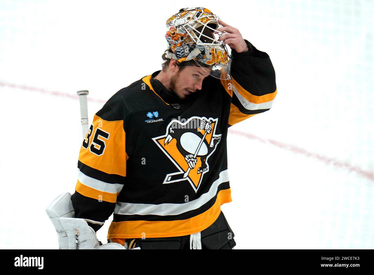Pittsburgh Penguins goaltender Tristan Jarry pulls on his mask during a ...
