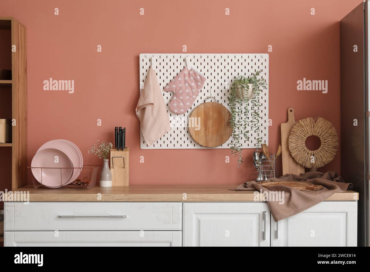 Interior of modern kitchen with cutting boards, pegboard and utensils ...