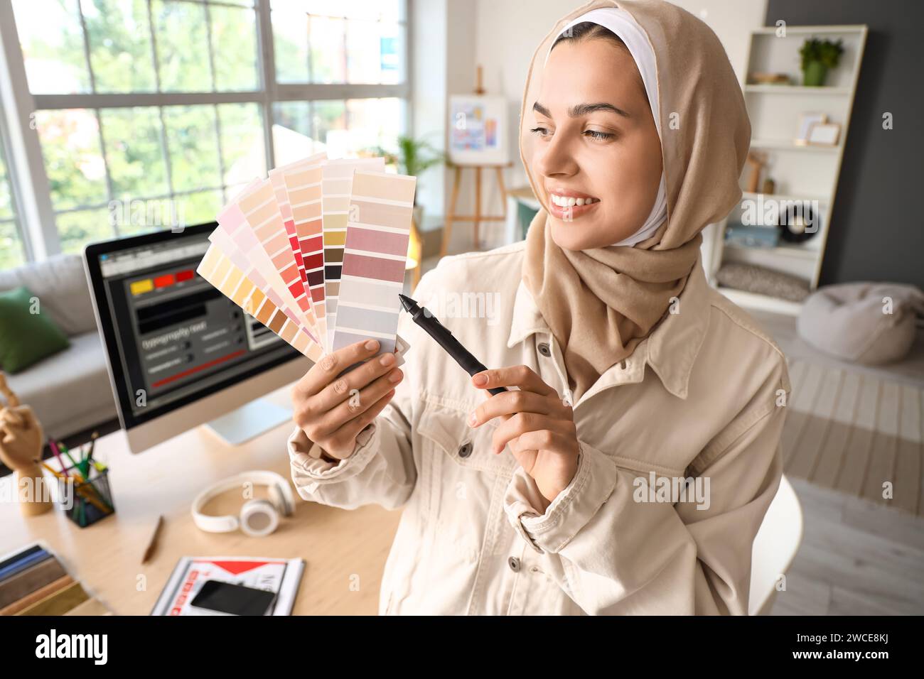 Muslim interior designer with color palettes in office Stock Photo - Alamy
