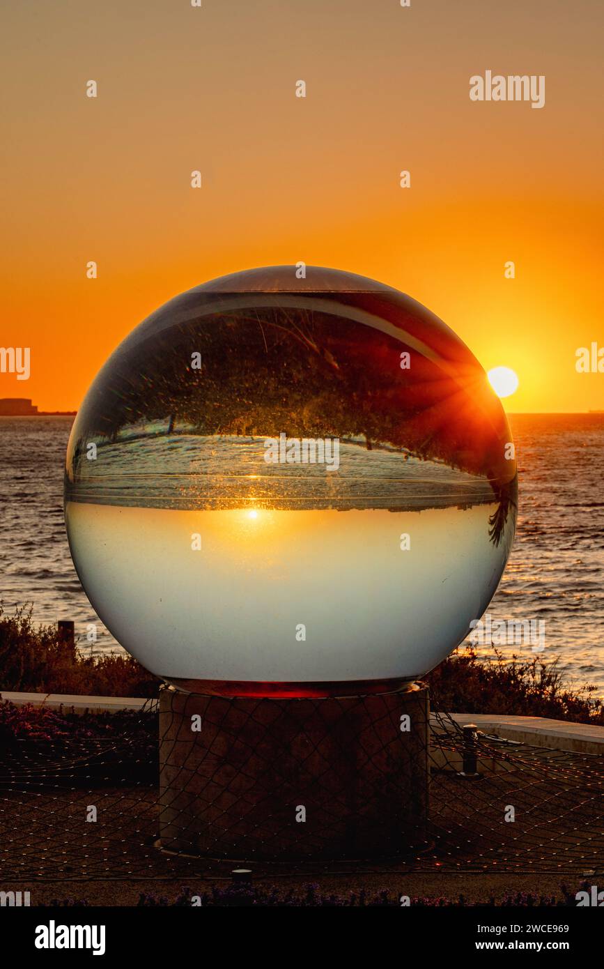 An exquisite glass orb filled with shimmering liquid, delicately ...