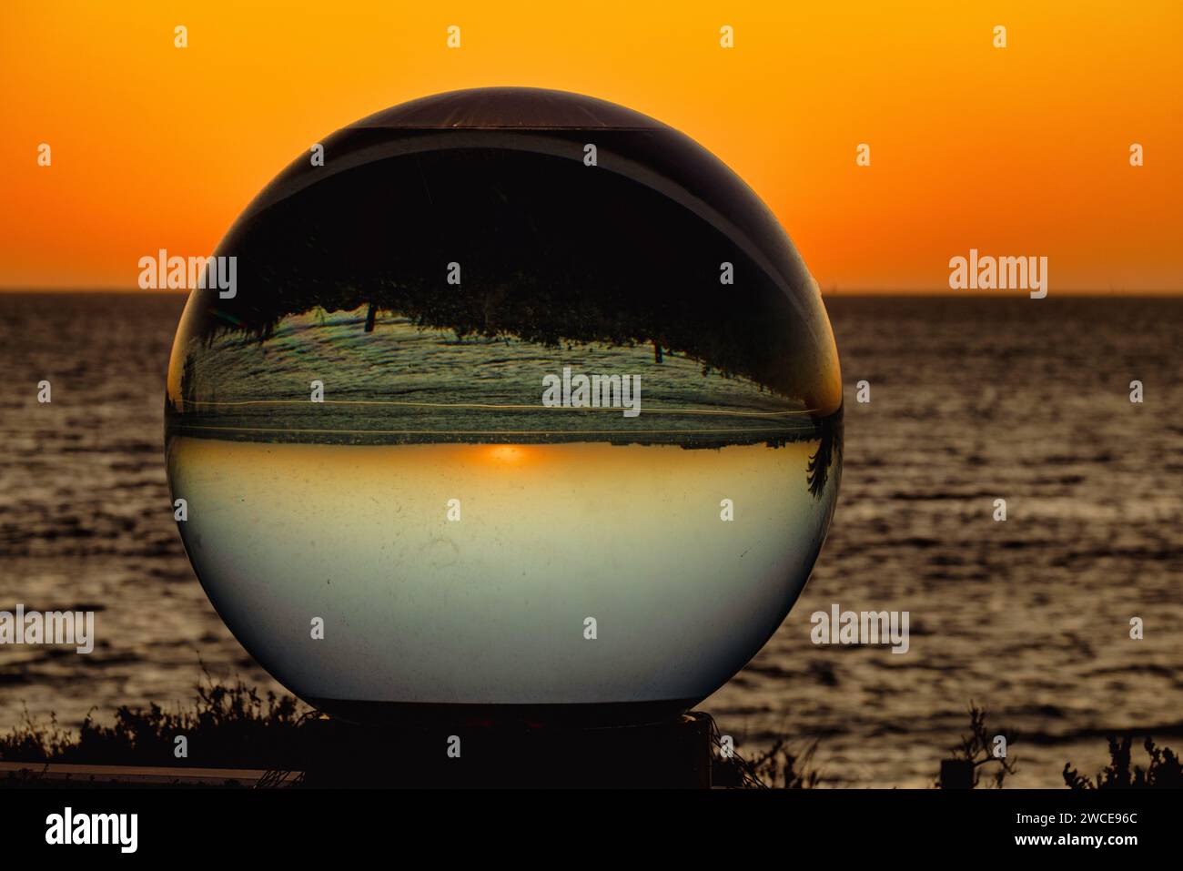 A magnificent transparent sphere gracefully perched on a sleek pole in ...