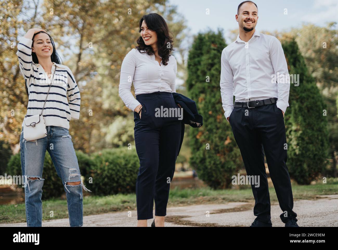 University students studying together in a sunny park, discussing ...