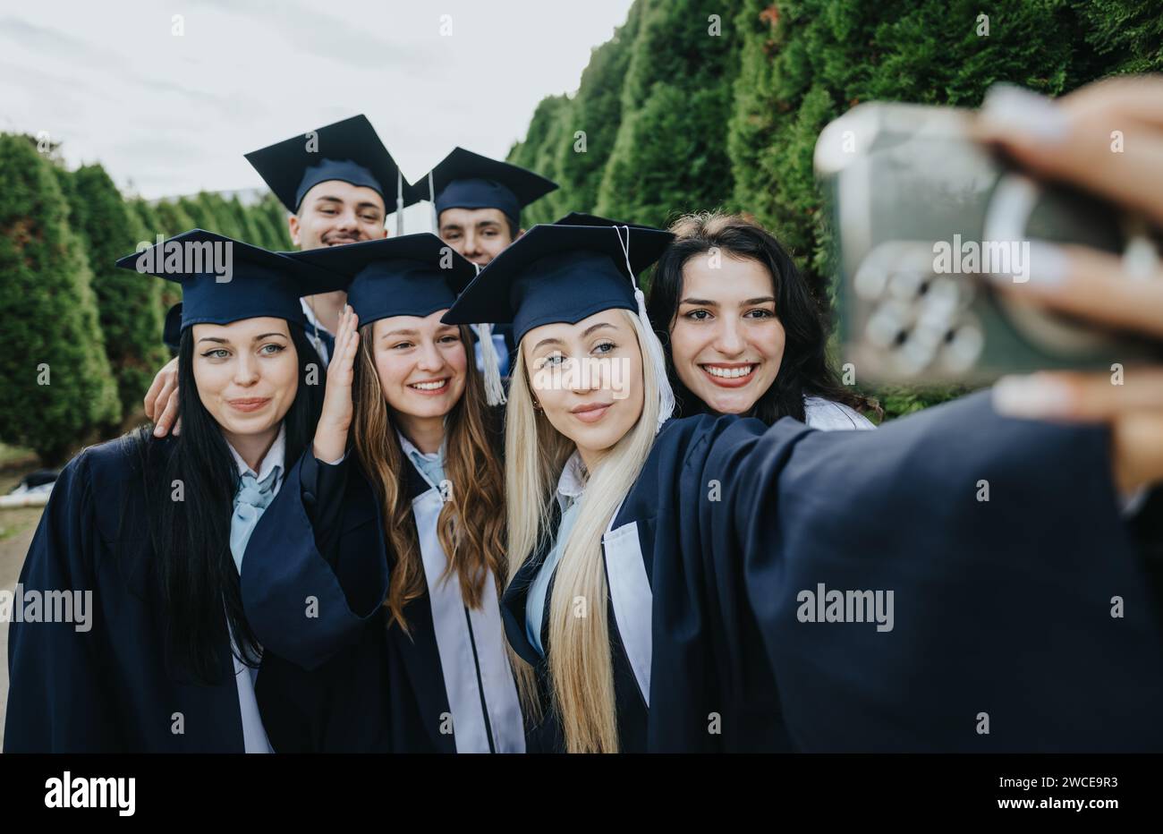 Graduated students in caps and gowns celebrate their achievements ...