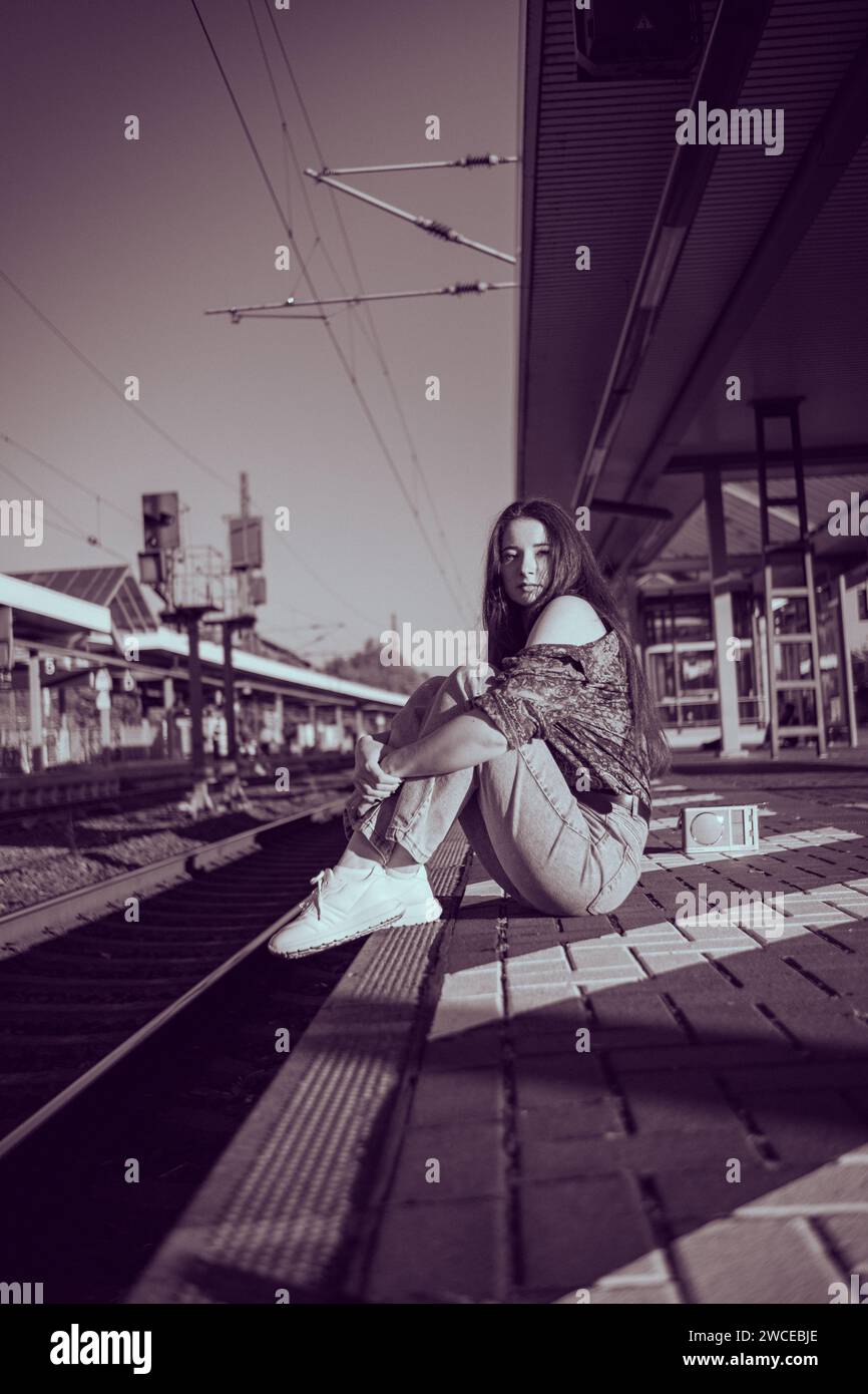 Beautiful caucasian girl posing on the railway platform. Girl dressed ...