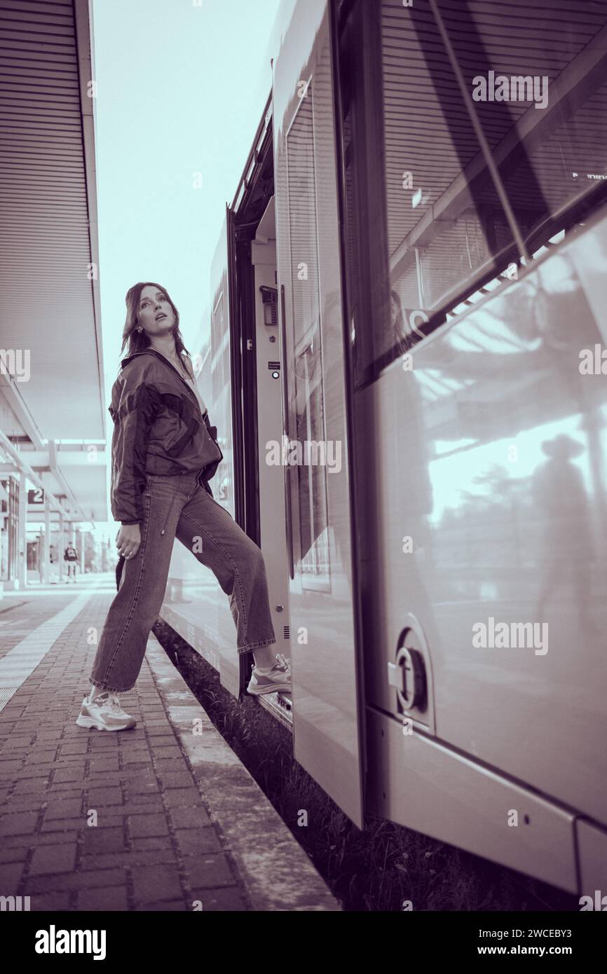 Caucasian looking girl jumping on the train at the last minute before ...
