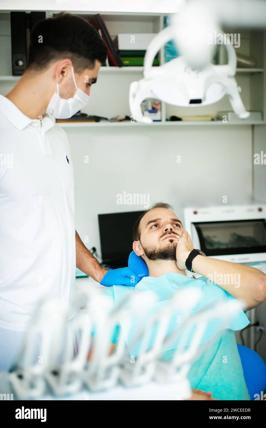 Unhappy patient having a toothache in dental clinic in professional ...