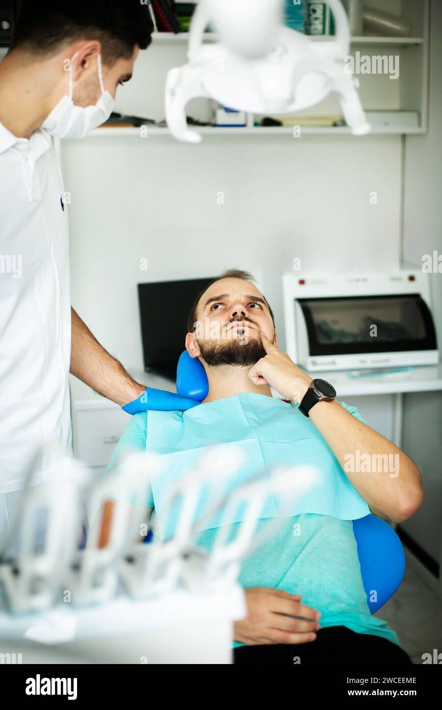 Unhappy patient having a toothache in dental clinic in professional ...