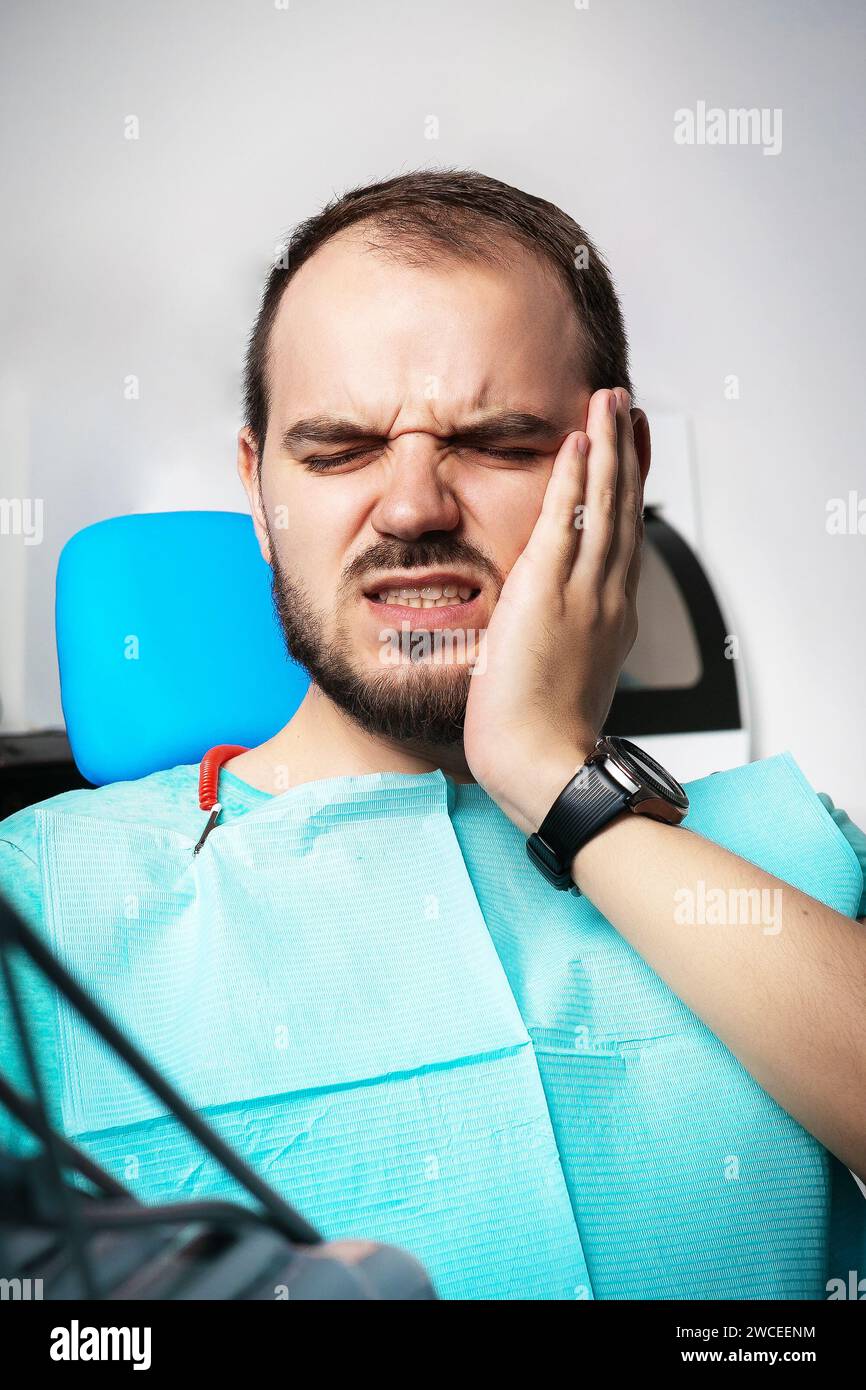 Unhappy patient having a toothache in dental clinic in professional ...