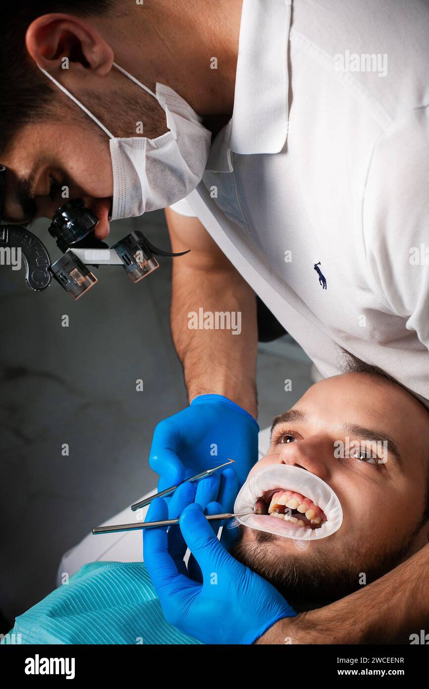 A patient in a dental chair with an optragate Stock Photo - Alamy