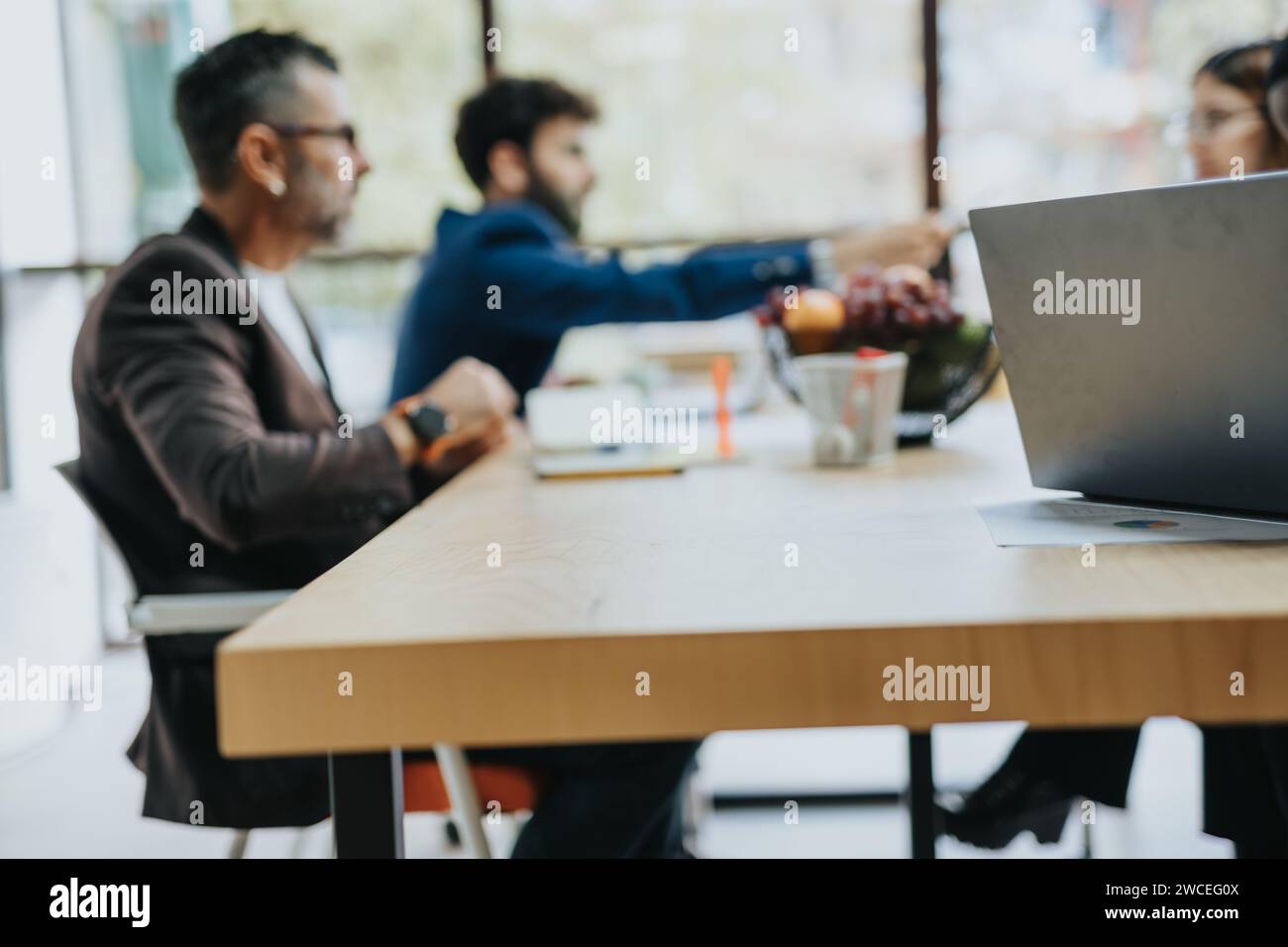 Different aged business team collaborates and discusses strategies for ...
