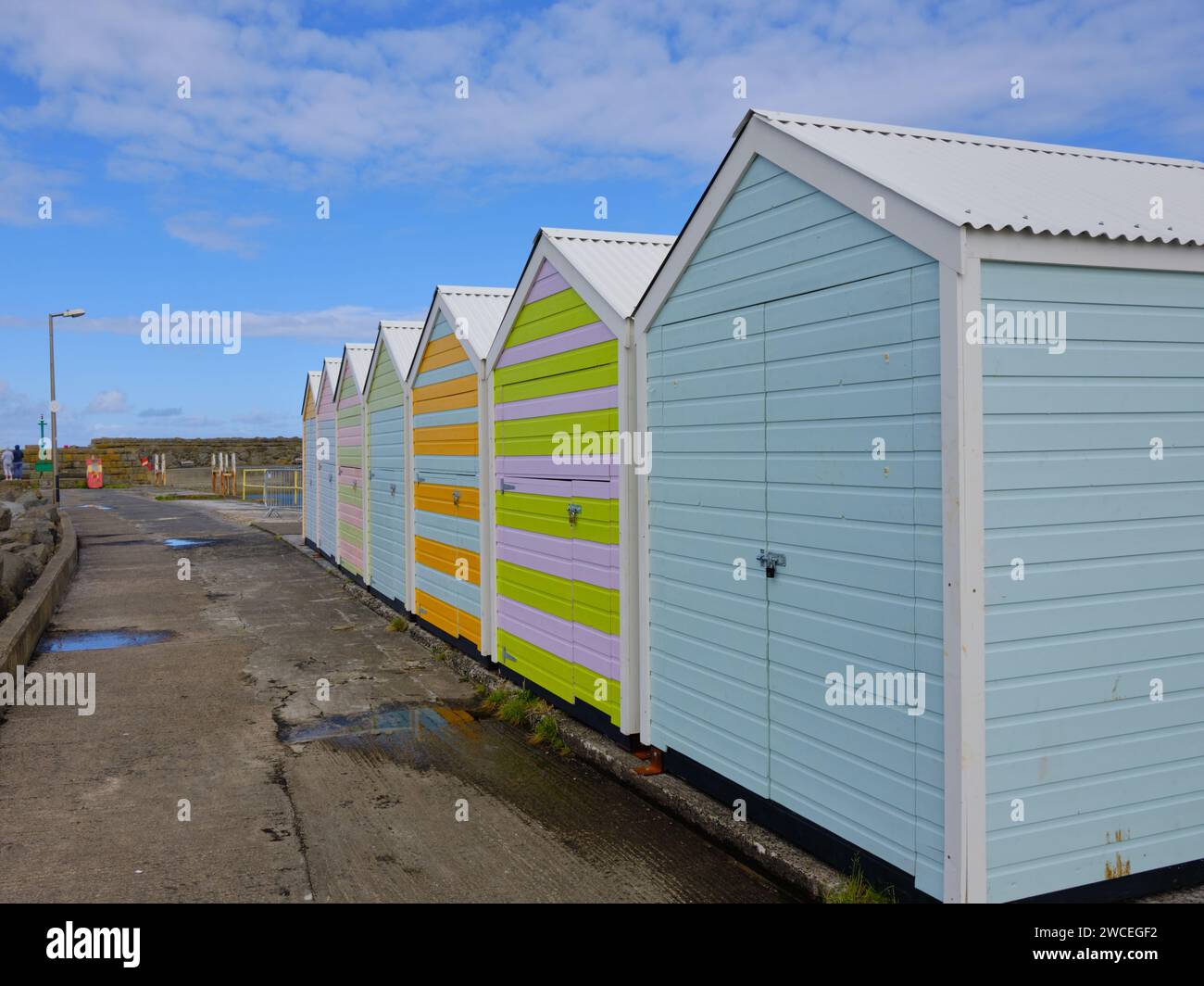 colourful change cabins, in a diagonal view, at beach parking lot ...