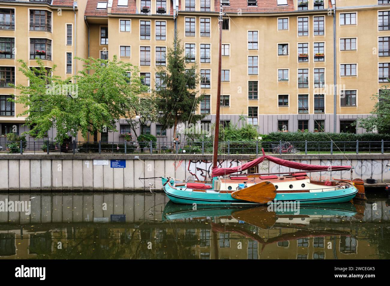 Boat anchored along one of the side canal of the Spree River, with ...