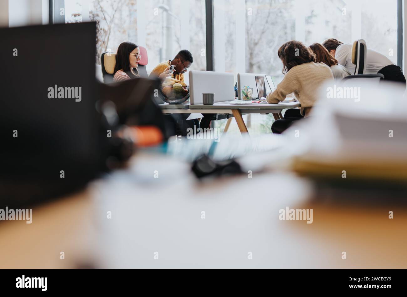 Coworkers collaborating in a modern space, discussing projects and ...