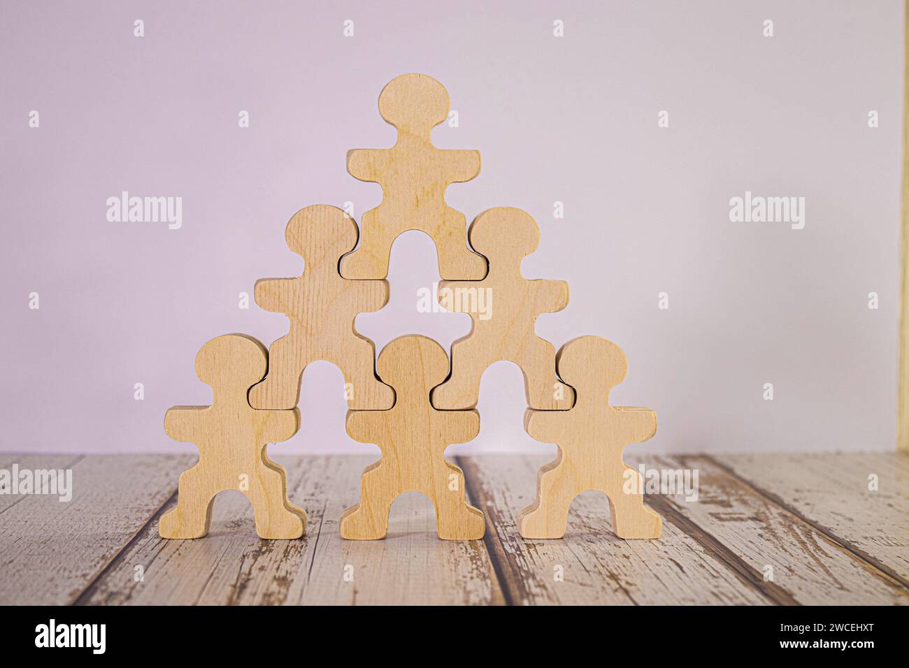 wooden unpainted nesting dolls stand on each other on white background ...