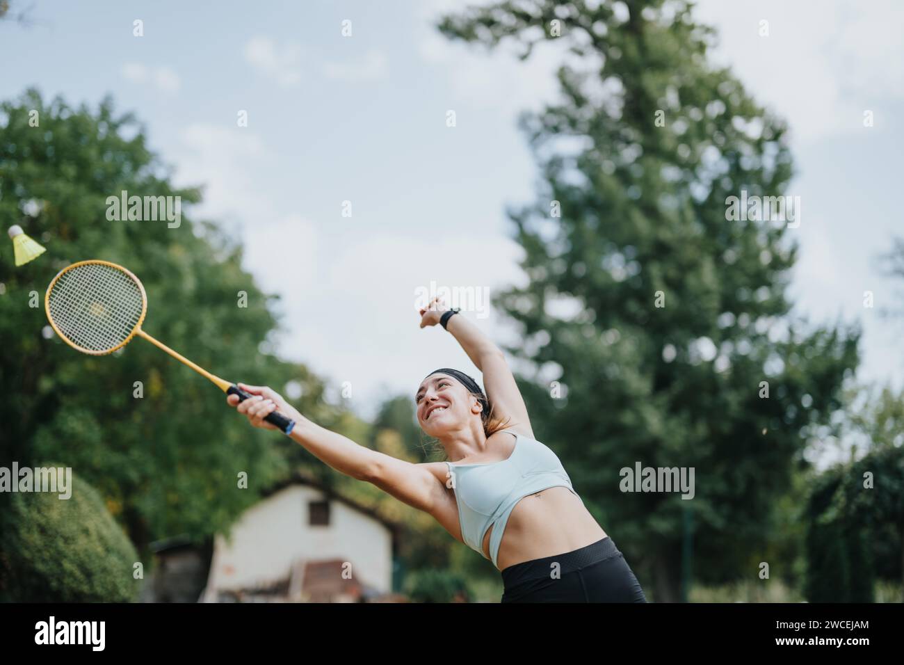Female, badminton player reaching for a shuttle with a racket Stock ...