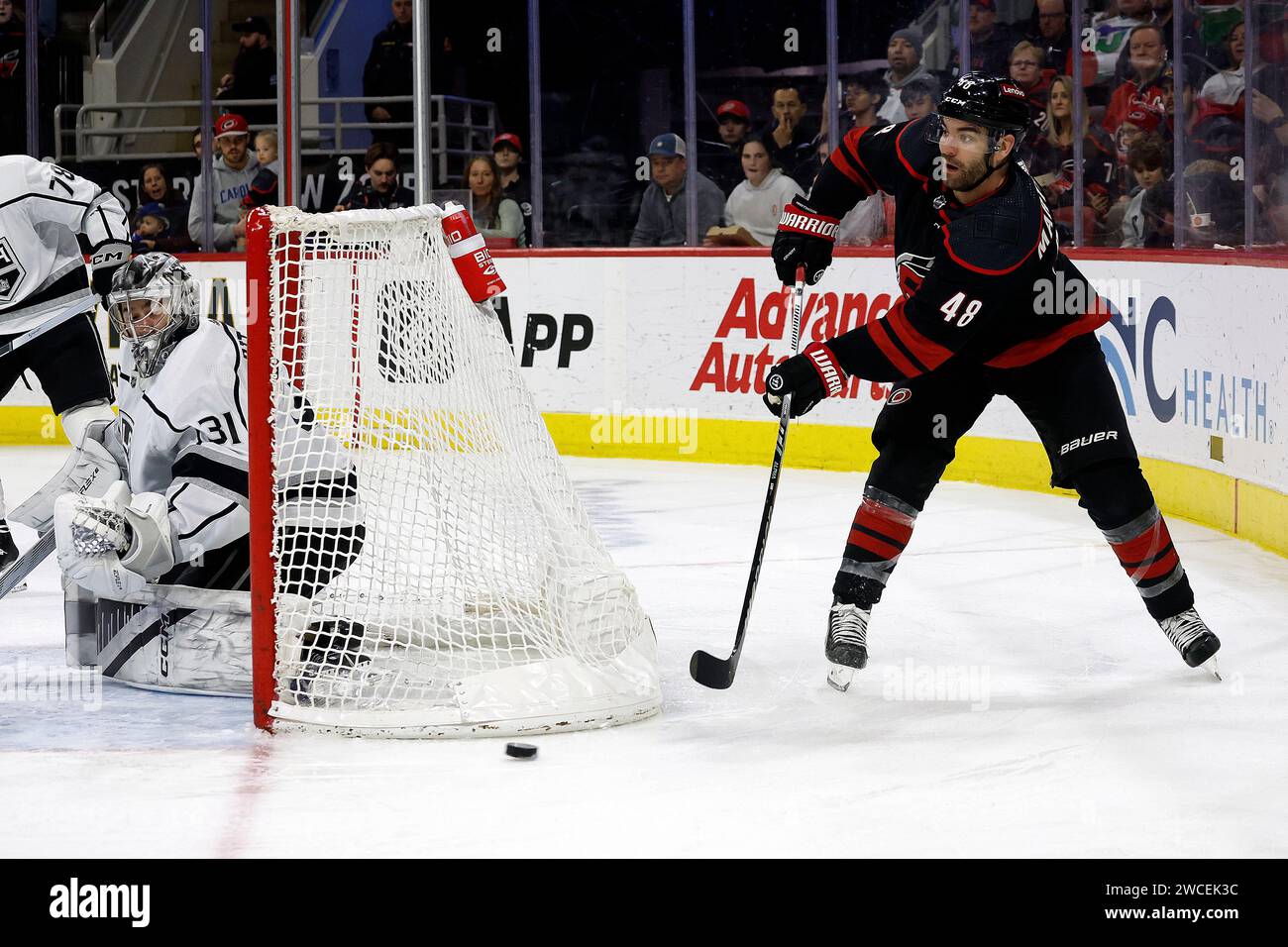 Carolina Hurricanes' Jordan Martinook (48) moves the puck behind the ...