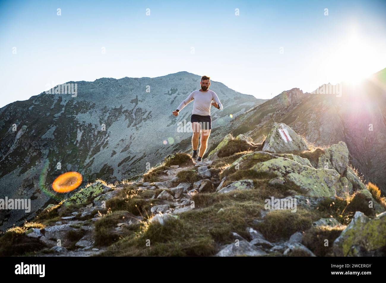 trail runner running in mountain landscape at sunset active lifestyle ...