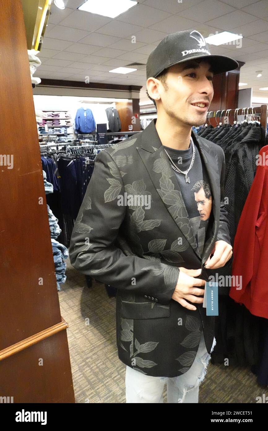 A Gen Z man trying on a Perry Ellis sports coat in a department store ...