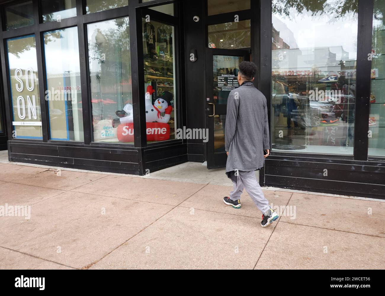 Gen Z man walking toward a sneaker store on Lower Greenville Avenue in ...