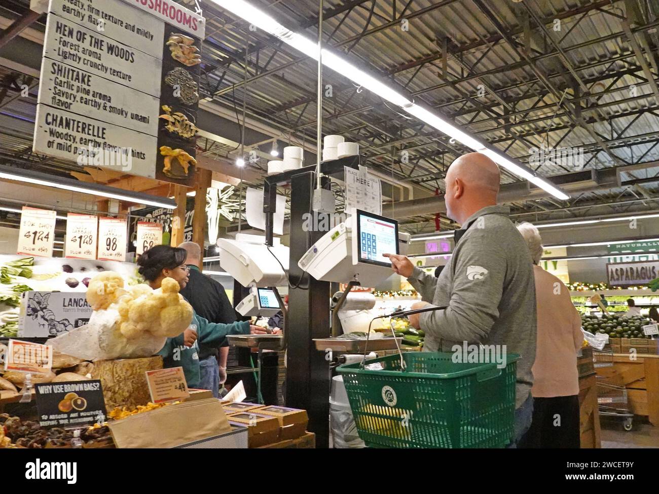 Customers shopping in the produce section of a Central Market grocery ...