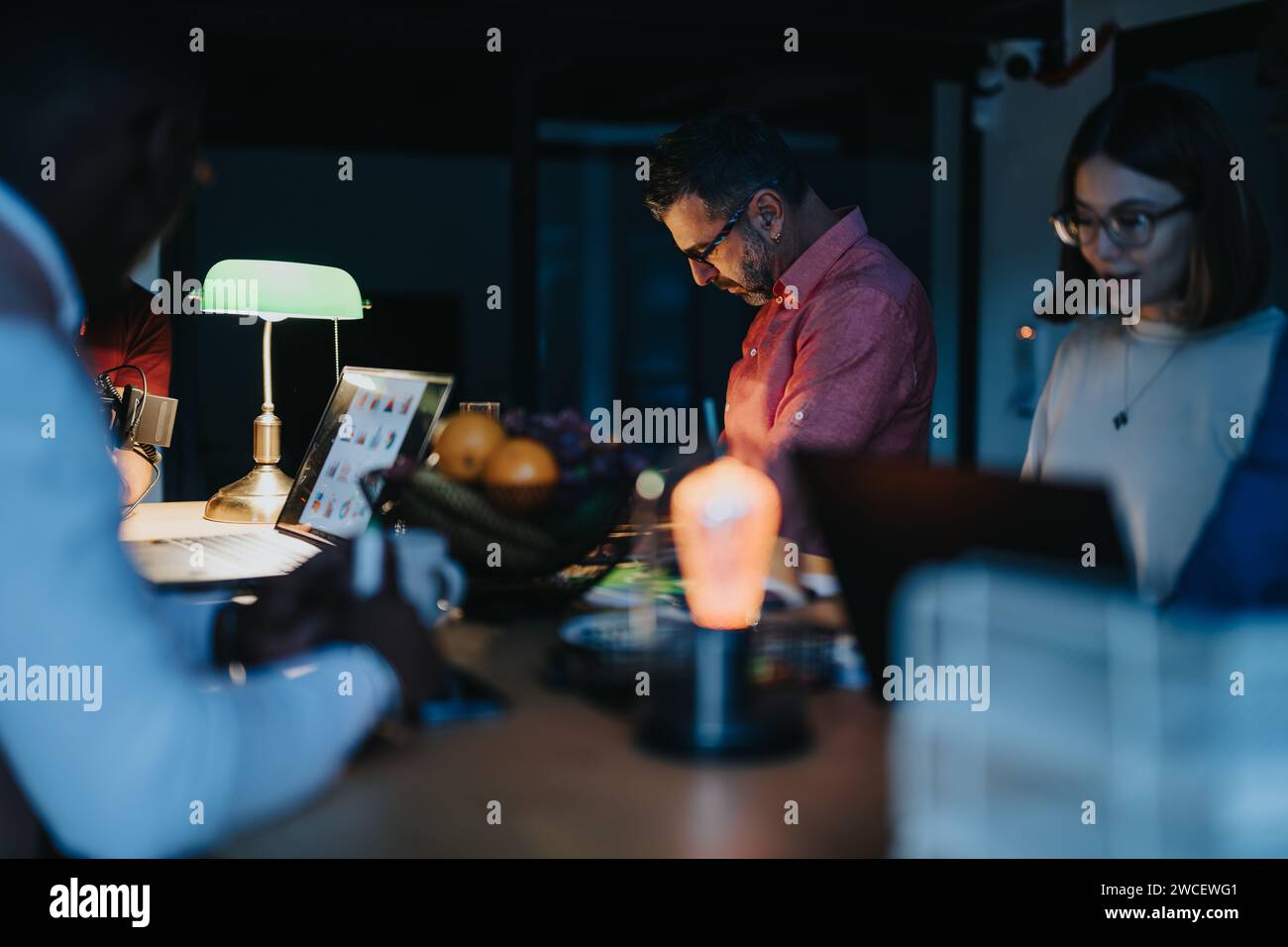 Multiracial business team collaborating on project details, analyzing ...