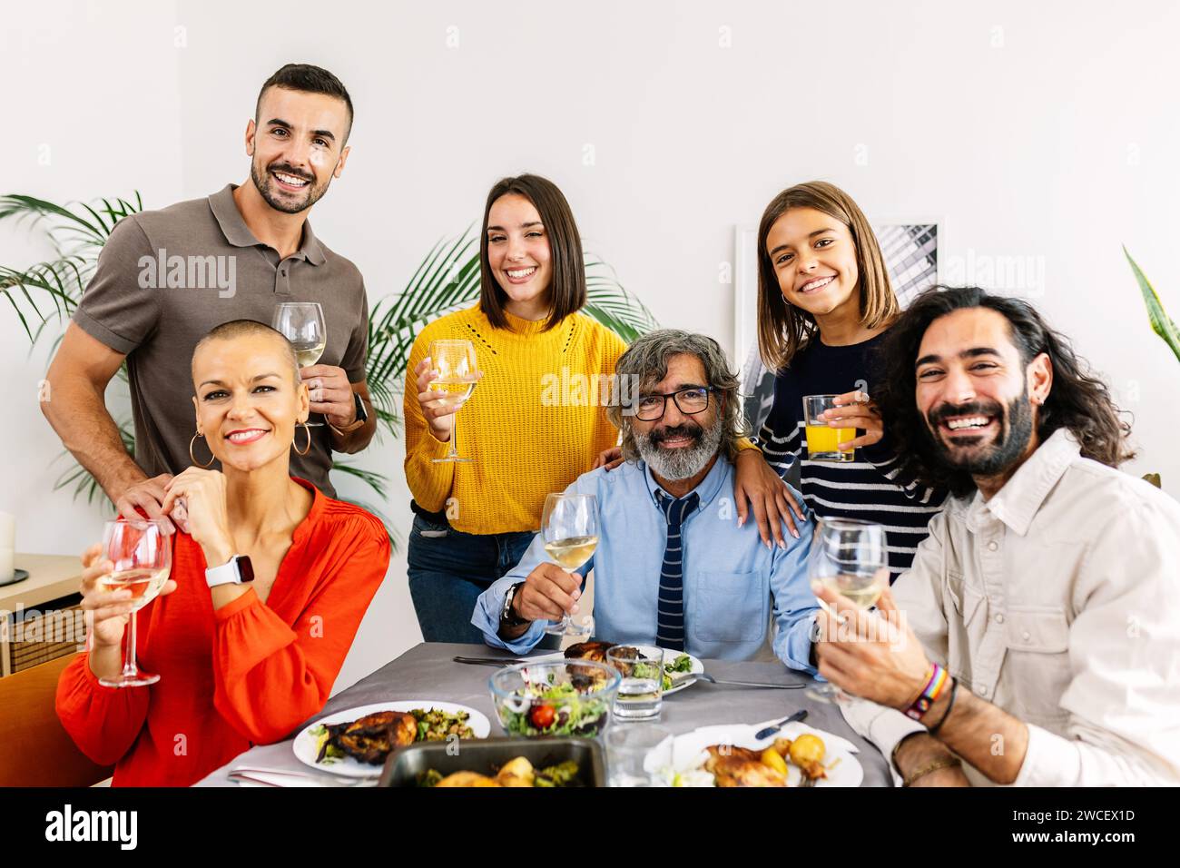 Portrait group of multi-generational family enjoying dinner party at ...