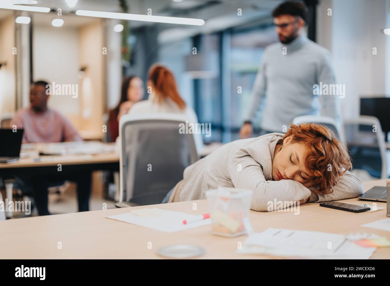 Exhausted businesswoman sleeping at work after rough working shift ...