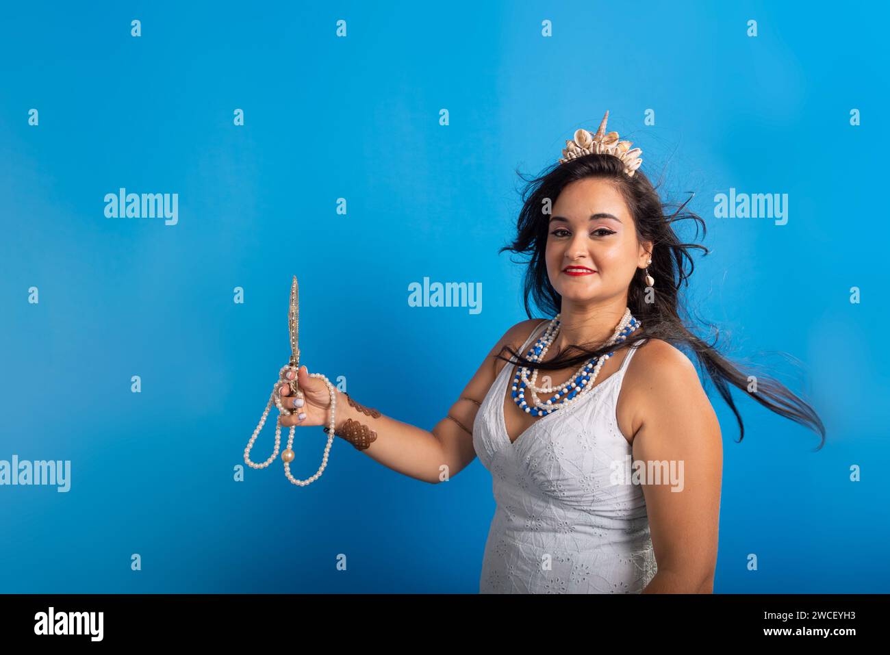 Portrait of beautiful black-haired woman wearing white clothes, smiling ...
