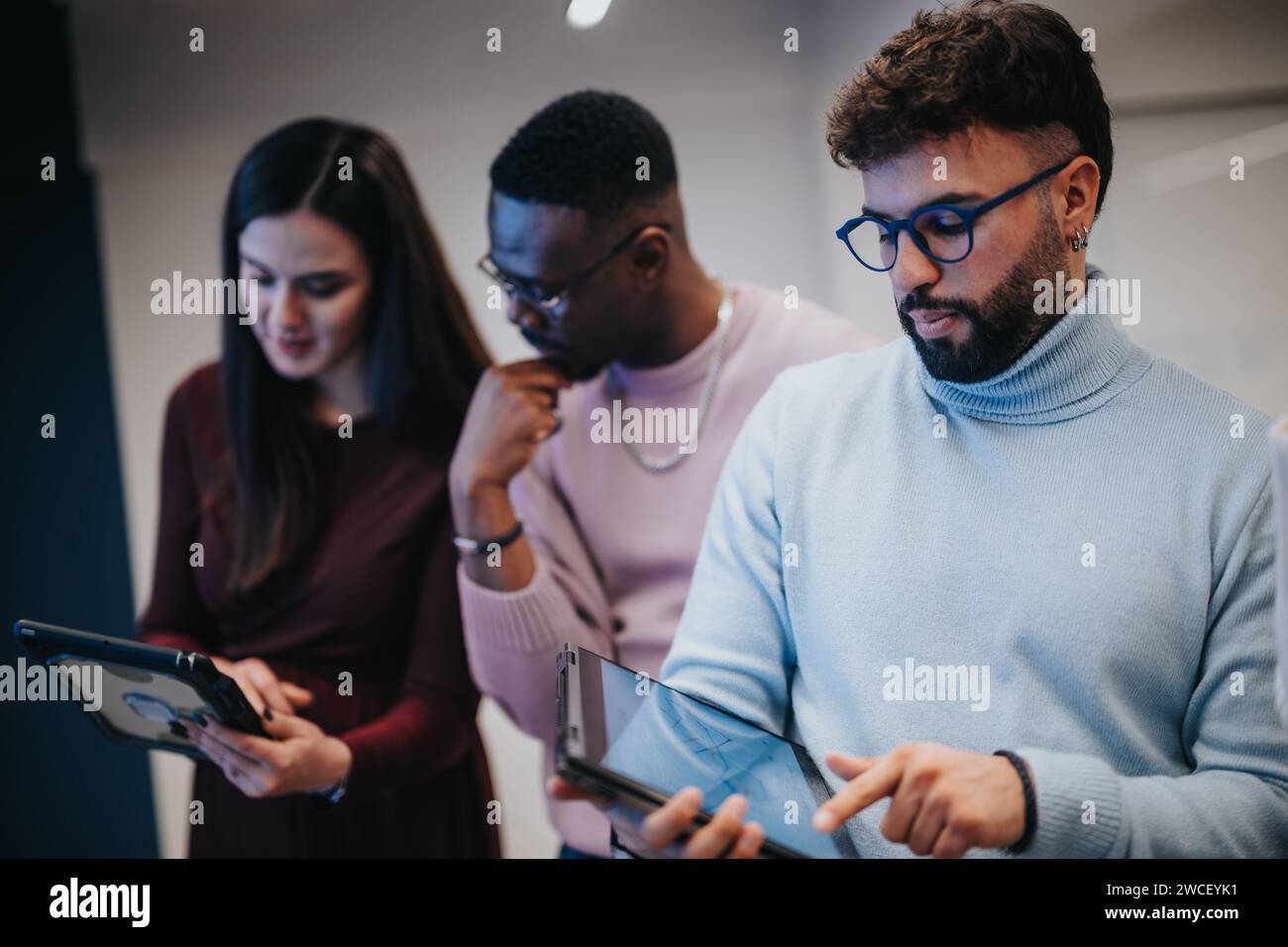 Multiracial professionals collaborating on business strategies ...