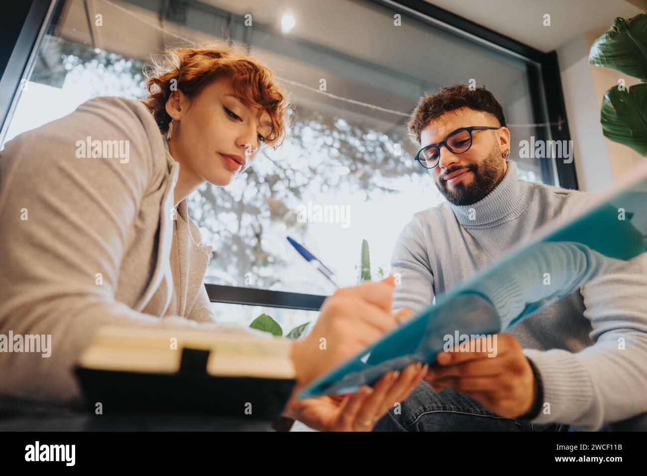 Confident colleagues collaborating in a creative office for business ...